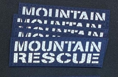 MOUNTAIN RESCUE navy laser cut velcro patch with silver reflective text.